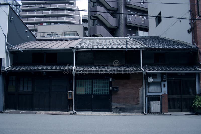 Black Wooden Wall Paint Building in Front of Grey High Rise Building ...