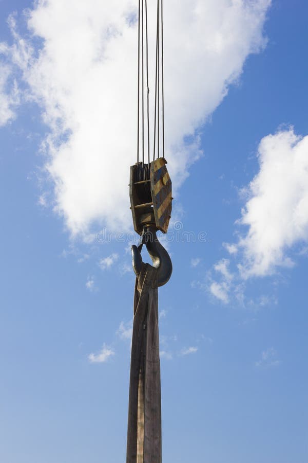 Black and Yellow Cargo Crane Hook with Slings, Against a Blue Sky with ...