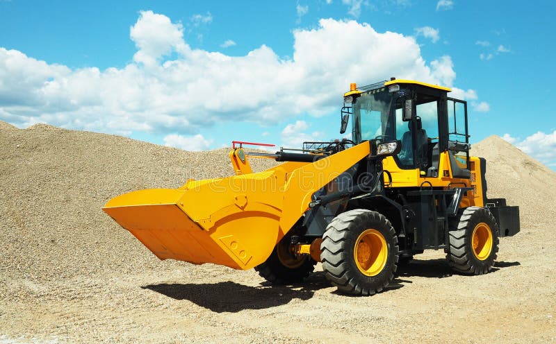 Black-yellow Front Loader with Small Wheels Against the Background of a ...