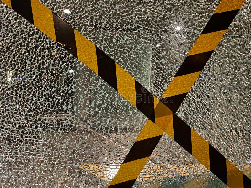 Black and Yellow Tape on a Cracked Window Stock Image - Image of ...