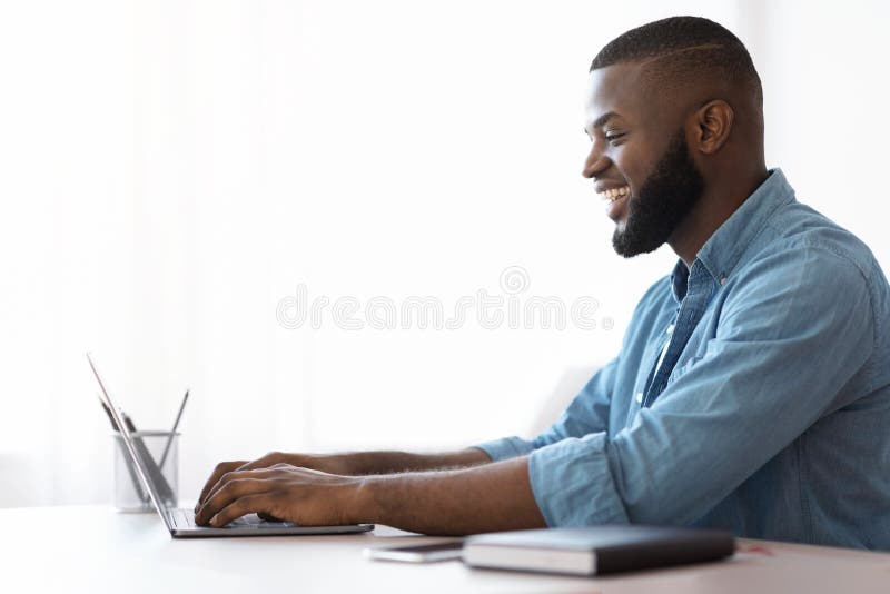 Black Young Man Using Laptop at Home, Enjoying Remote Work, Side View ...