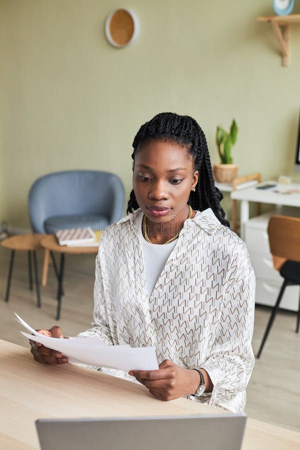 Black Young Woman Using Laptop in Minimal Office Setting Stock Photo ...
