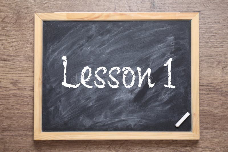 Blackboard with Phrase LESSON 1 on Background, Top View Stock Photo ...