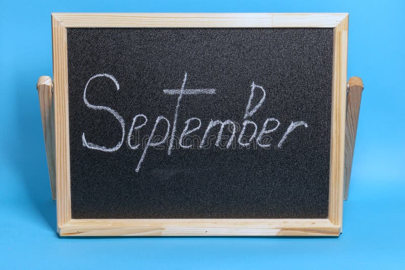 Blackboard with the Word Chalked September on Blue Background Stock ...