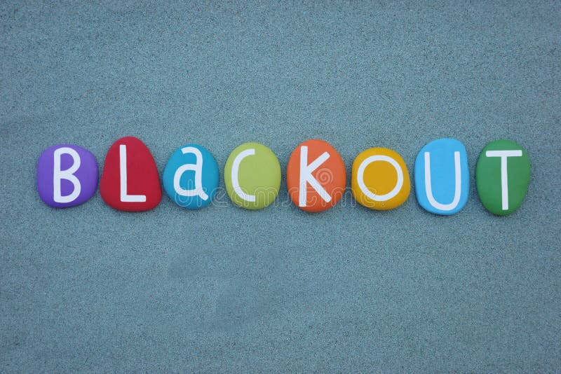 Blackout Word Composed with Multi Colored Stone Letters Over Green Sand ...