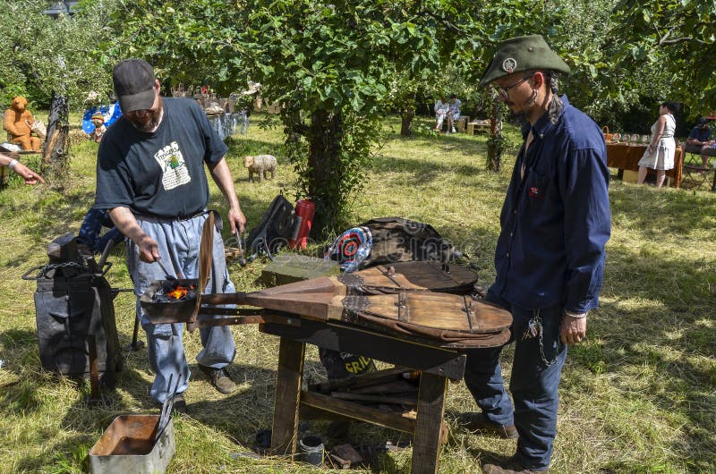 Blacksmith with the Ancient Bellows Blowing the Coals for Forging ...