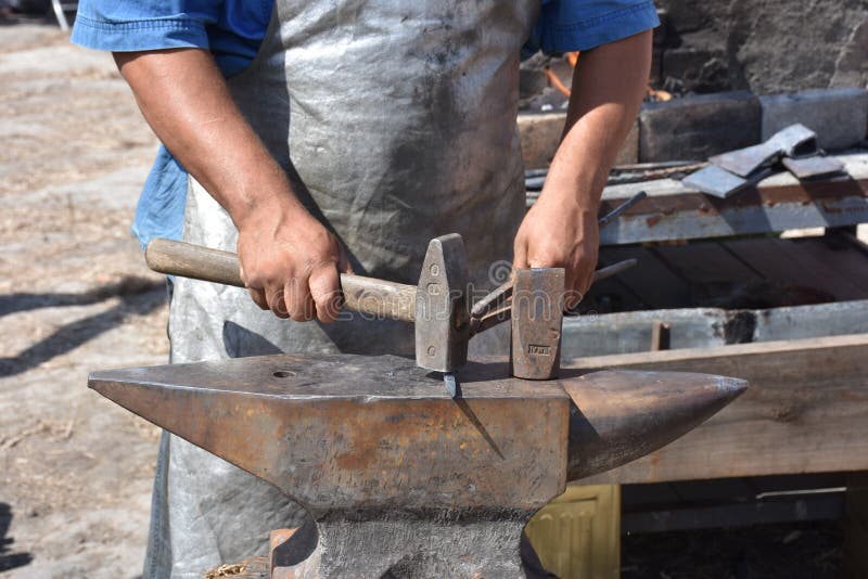 Blacksmith Beating Iron in Old Fashion Stock Photo - Image of anvil ...
