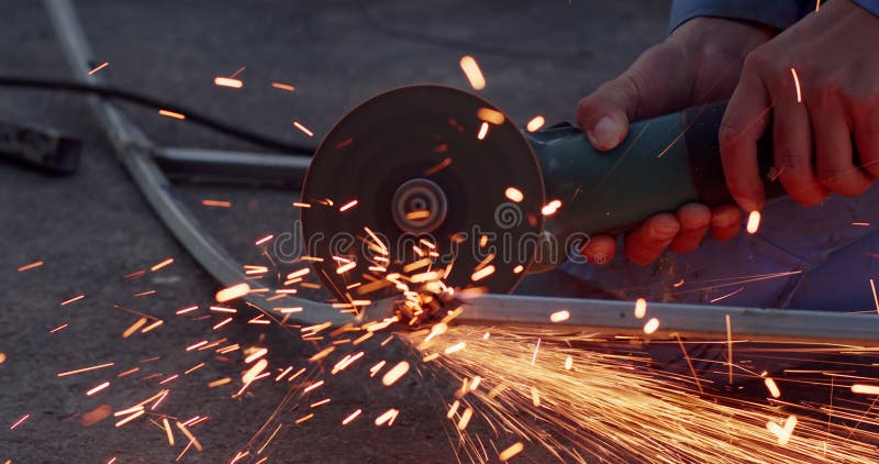 Blacksmith Cutting Metal Using Angle Grinder while Working in ...
