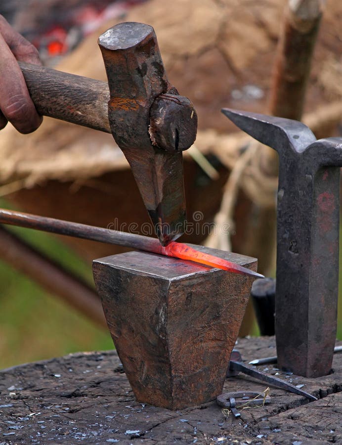 Blacksmith Forge a Nail with a Hammer on the Anvil Stock Image - Image ...