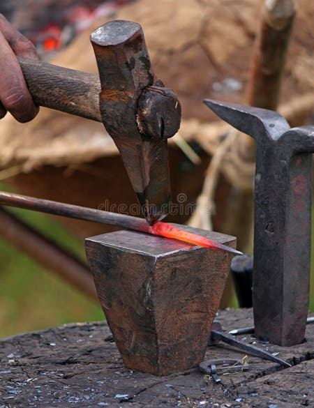 Blacksmith Forge a Nail with a Hammer on the Anvil Stock Image - Image ...