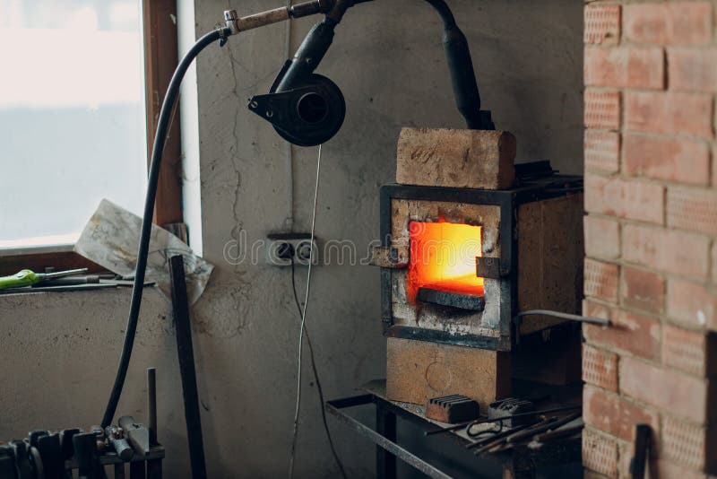 Blacksmith Forge Oven with Hot Flame. Smith Heating Iron Piece of Steel ...