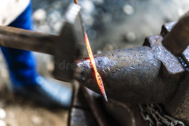 Blacksmith in a Forge at Work on an Anvil. Hot Metal Forging Stock ...
