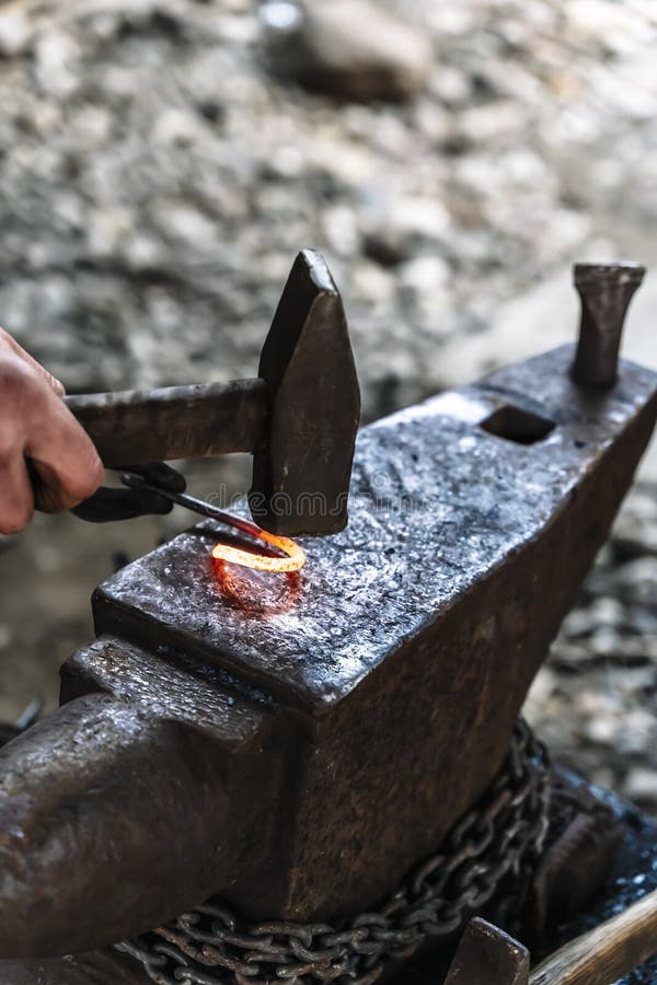 Blacksmith in a Forge at Work on an Anvil. Hot Metal Forging Stock ...