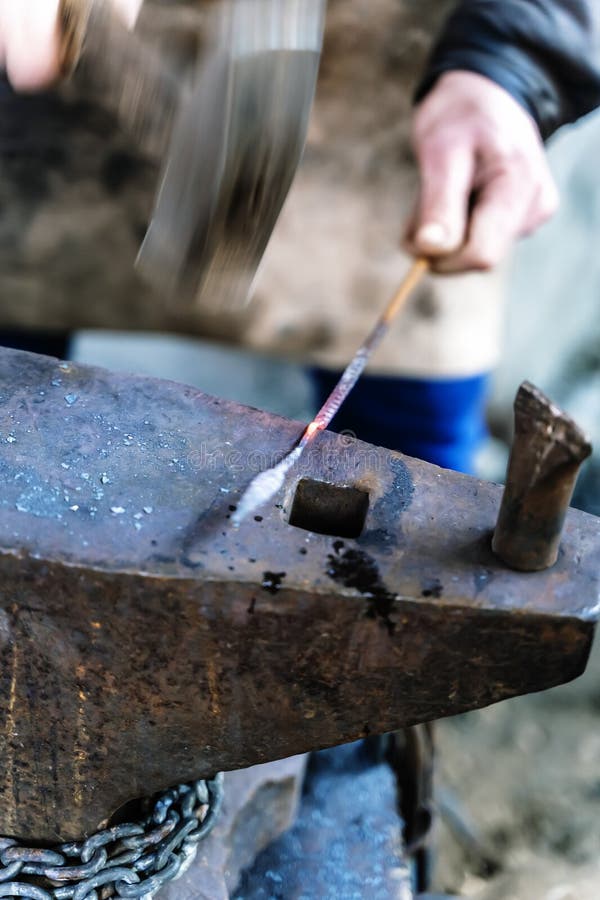 Blacksmith in a Forge at Work on an Anvil. Hot Metal Forging Stock ...