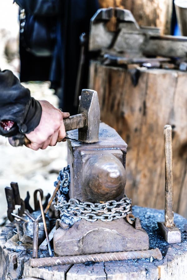 Blacksmith in a Forge at Work on an Anvil. Hot Metal Forging Stock ...