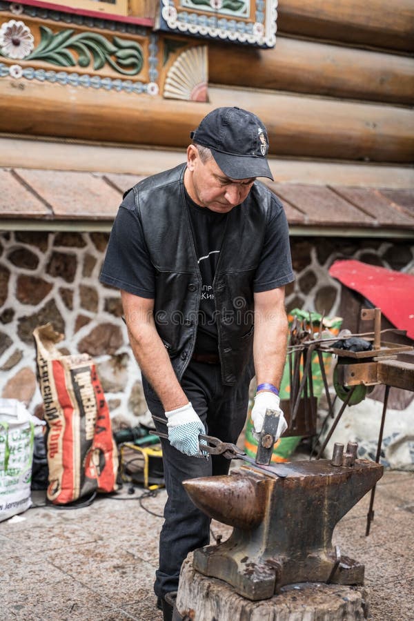 Blacksmith Forges Item on the Anvil. Editorial Photography - Image of ...