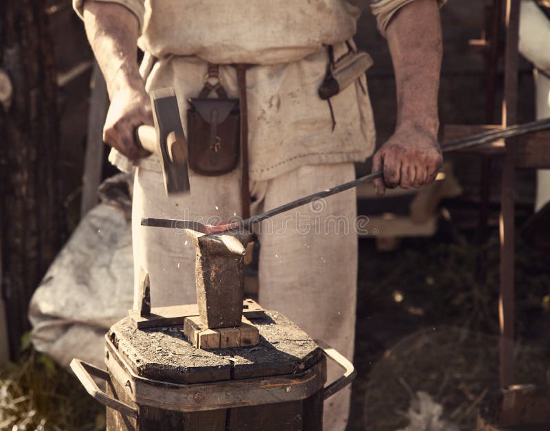 Blacksmith Forges Part on Anvil in Antique Clothes Stock Image - Image ...