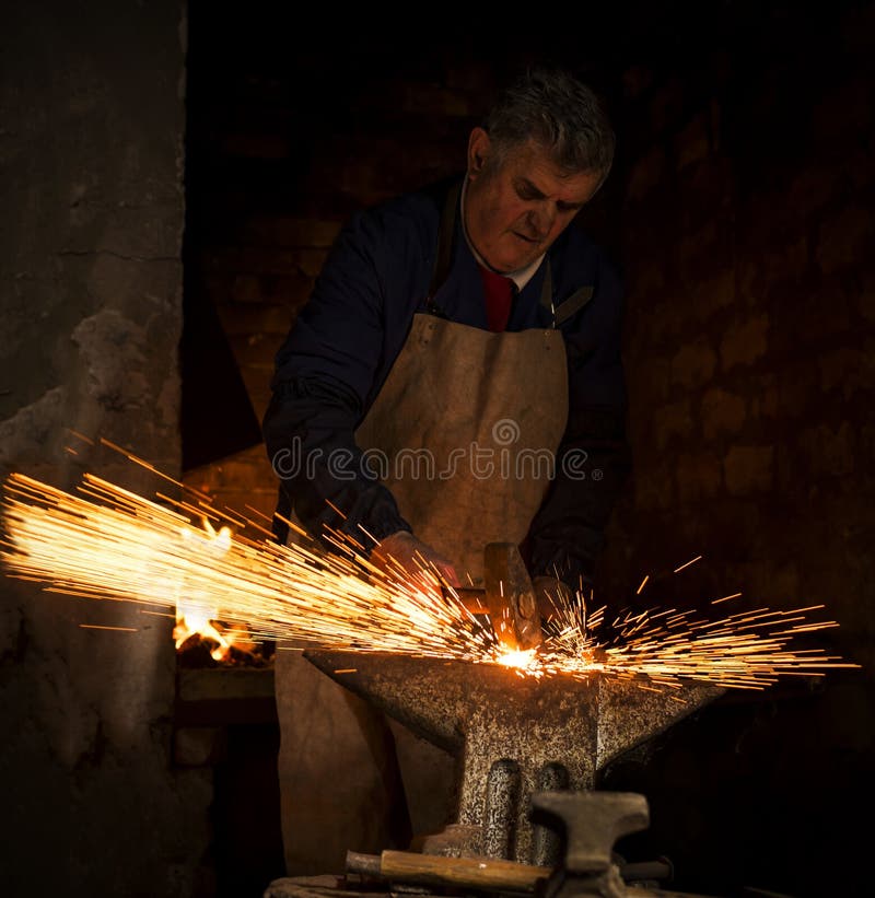Blacksmith Forging the Hot Metal on the Anvil in Smithy Stock Photo ...