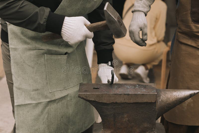 The Blacksmith Forging the Metal on the Anvil in Smithy Stock Image ...