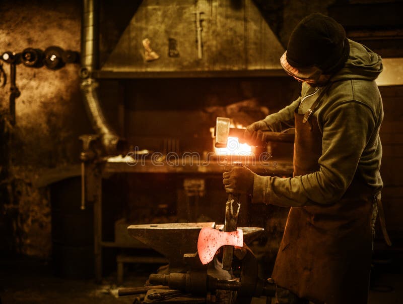 The Blacksmith Forging the Molten Metal on the Anvil in Smithy Stock ...
