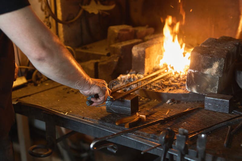 Blacksmith Manually Forging on Iron on Anvil at Forge. Treatment of ...