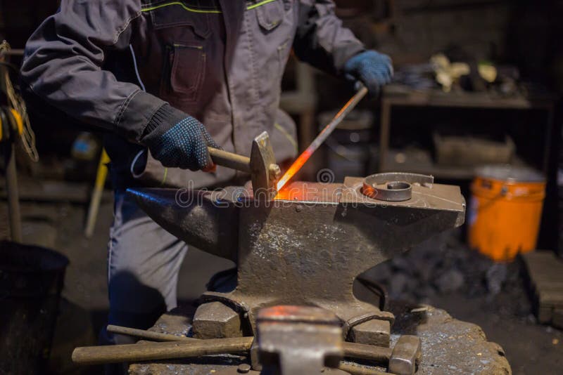 Blacksmith Forging Molten Metal Stock Photo - Image of male, heavy ...