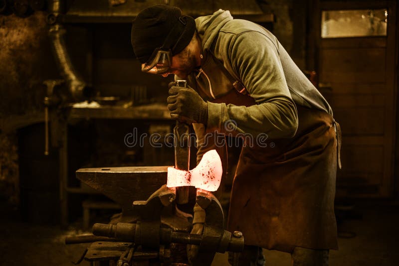 Blacksmith Forging the Molten Metal on the Rusty Vise in Smithy Stock ...