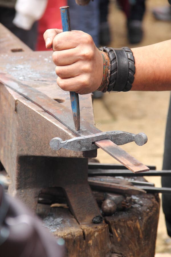 Blacksmith forging a sword stock image. Image of molten - 64589605