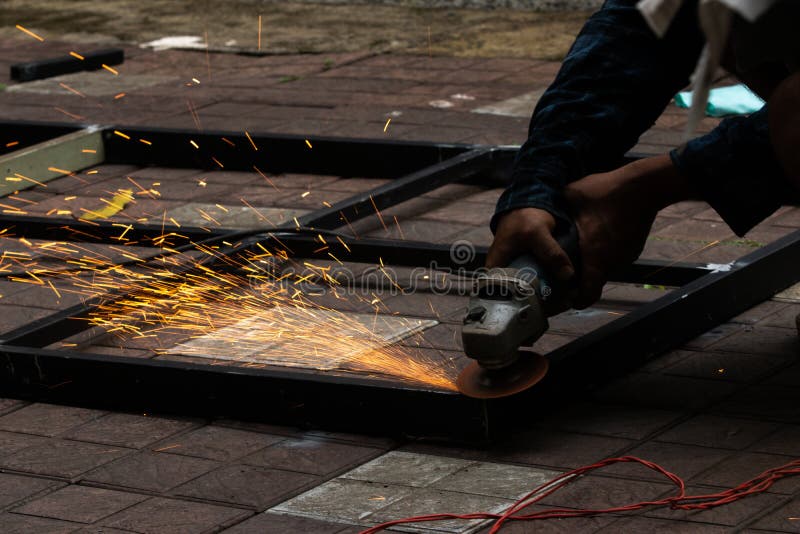 Blacksmith on Grinding Works on a Metel Frame Stock Photo - Image of ...