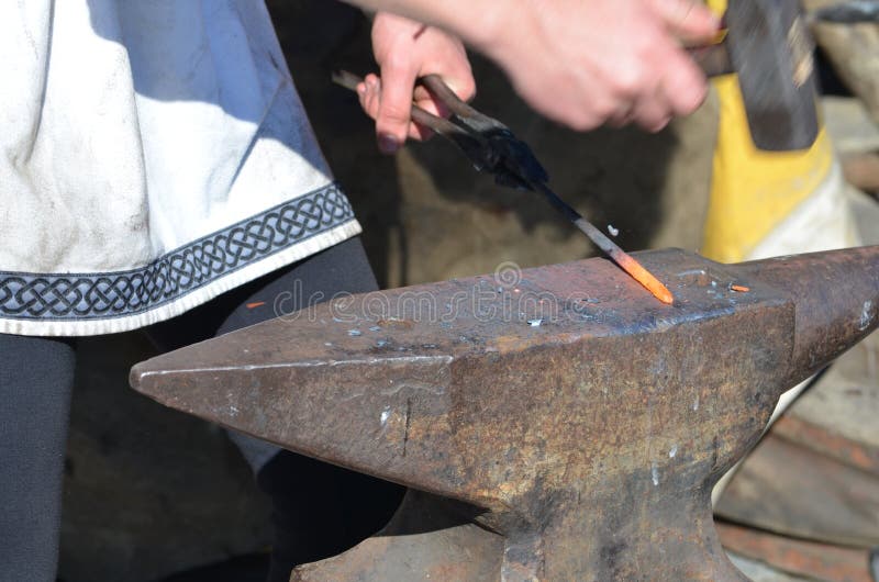 Blacksmith Hammers Red Hot Iron on an Anvil Stock Image - Image of ...
