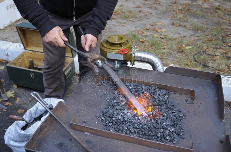 Blacksmith Hand Holding Forceps with a Metal Billet in a Burning Forge ...