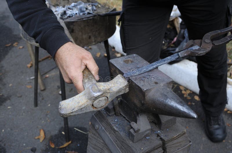 Blacksmith Hand Holding Forceps with a Metal Billet in a Burning Forge ...
