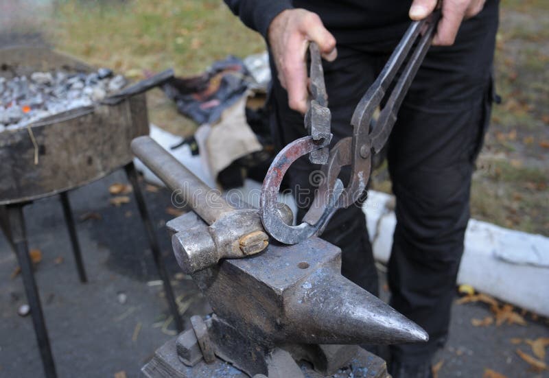 Blacksmith Hand Holding Forceps with a Metal Billet in a Burning Forge ...
