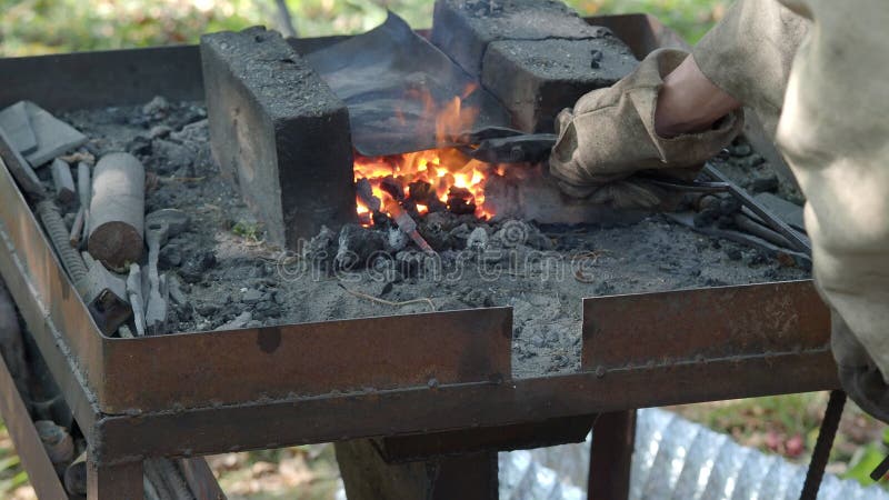 Blacksmith Heated the Iron Rod in Burning Coals in Forge Stock Footage ...