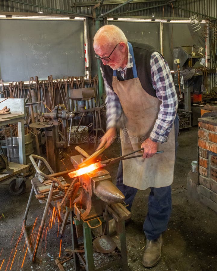 A Blacksmith at his Anvil editorial stock photo. Image of industry ...