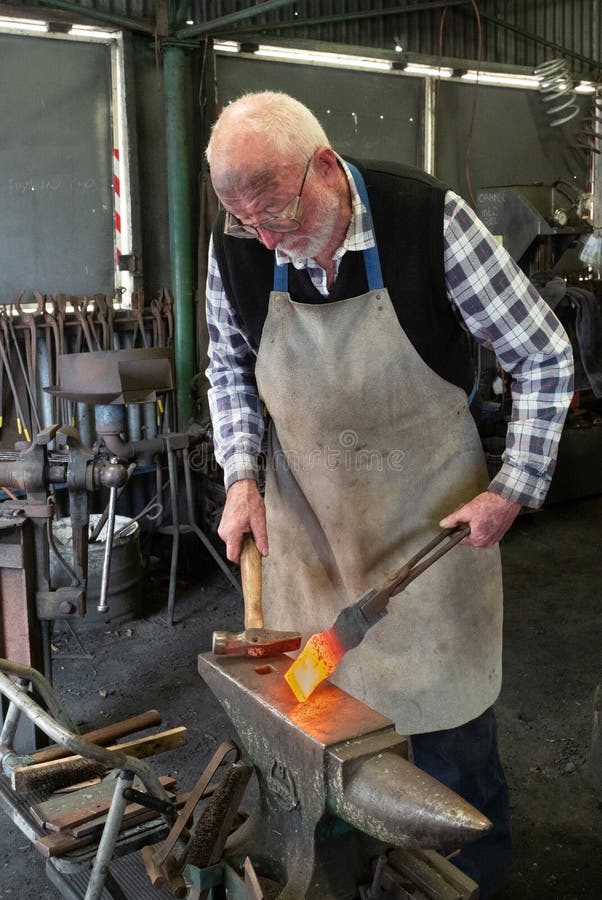 A Blacksmith at his Anvil editorial stock photo. Image of western ...