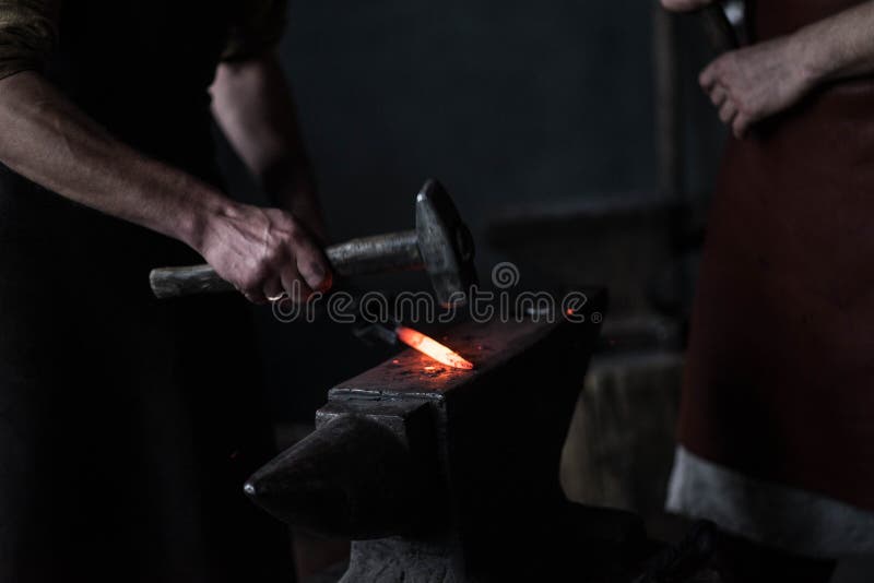 Blacksmith Hitting a Red-hot Iron with a Hammer Stock Image - Image of ...