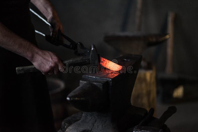 Blacksmith Hitting a Red-hot Iron with a Hammer Stock Photo - Image of ...