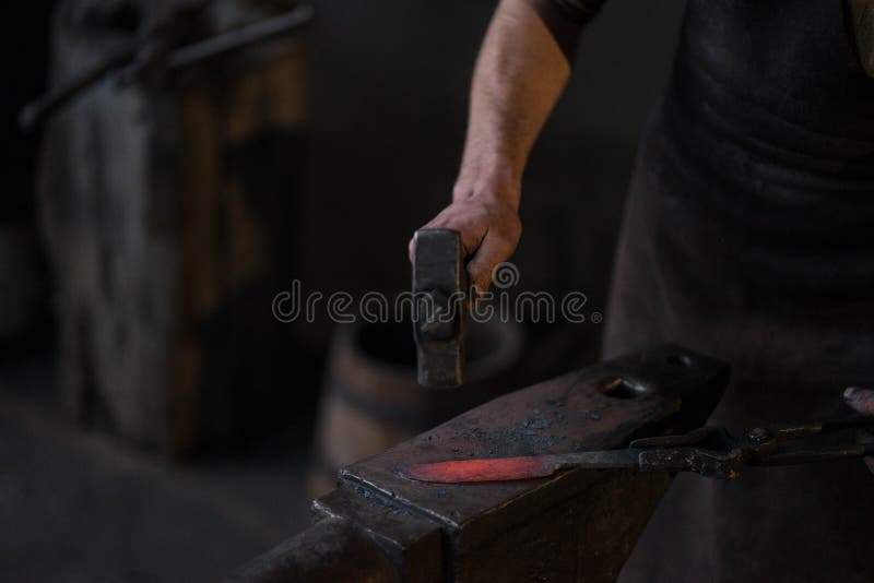 Blacksmith Hitting a Red-hot Iron with a Hammer Stock Photo - Image of ...