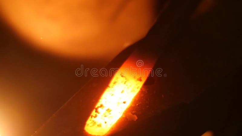 Blacksmith Hitting Hot Metal with a Hammer on an Anvil Inside His ...