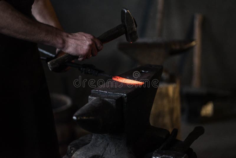 Blacksmith Hitting a Red-hot Iron with a Hammer Stock Image - Image of ...