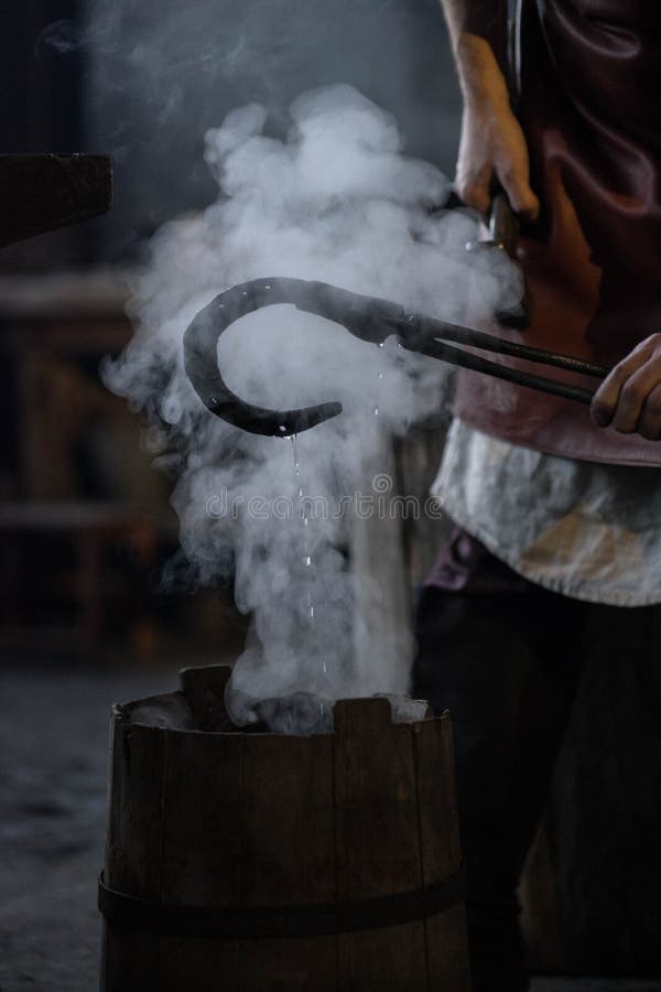 Blacksmith Holding Iron Work in Forge Stock Image - Image of metallurgy ...
