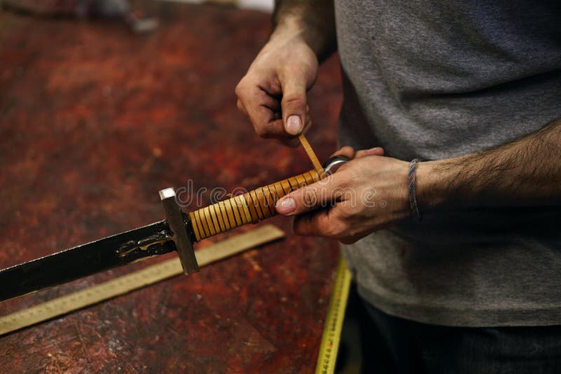 Blacksmith Makes Leather Winding Sword Stock Photo - Image of hilt ...