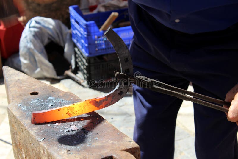 Blacksmith Making a Horseshoe from Heated Red Rod Stock Image - Image ...