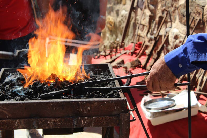 Blacksmith Making a Horseshoe from Heated Rod Stock Photo - Image of ...