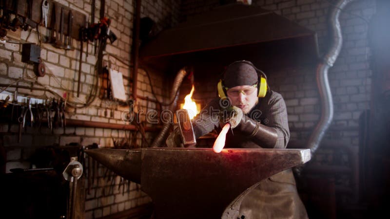 Blacksmith Making a Knife - Looking for Imperfections Stock Photo ...