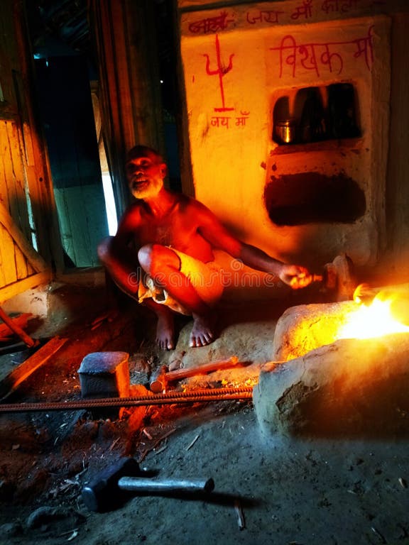 Blacksmith Making an Object by the Fire and a Hand Hammer in a Village ...