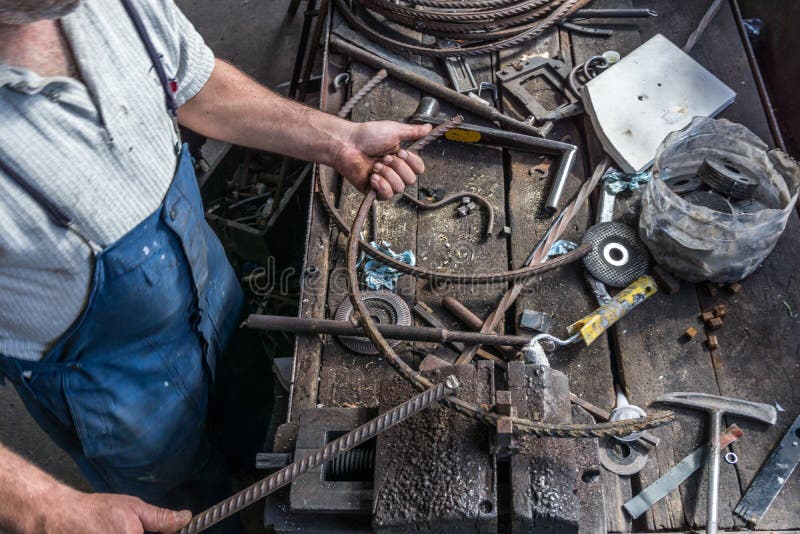 Blacksmith Making Wrought Iron with Industrial Bender Equipment Machine ...