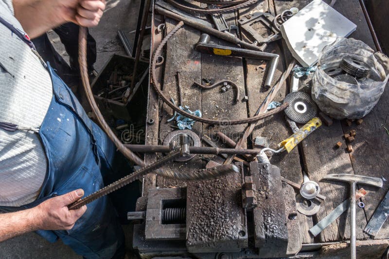 Blacksmith Making Wrought Iron with Industrial Bender Equipment Machine ...