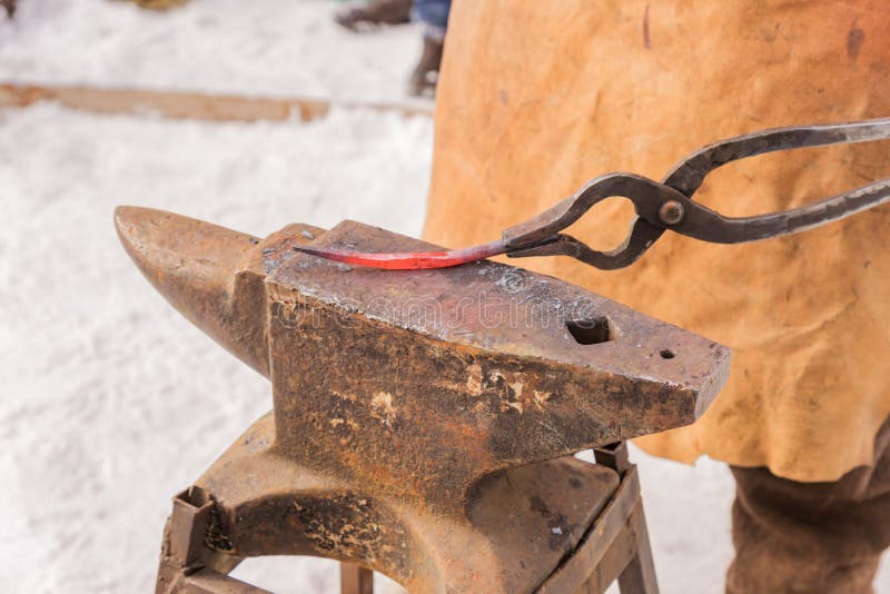 Blacksmith Manually Forging the Molten Metal on the Anvil Outdoors ...